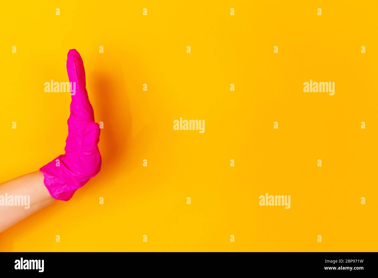 Hand in pink protective rubber glove greeting, waving isolated on ...