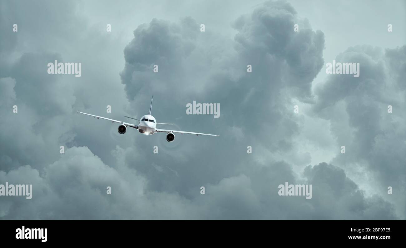 Passenger plane in flight. The aircraft flies high in the sky above the ...