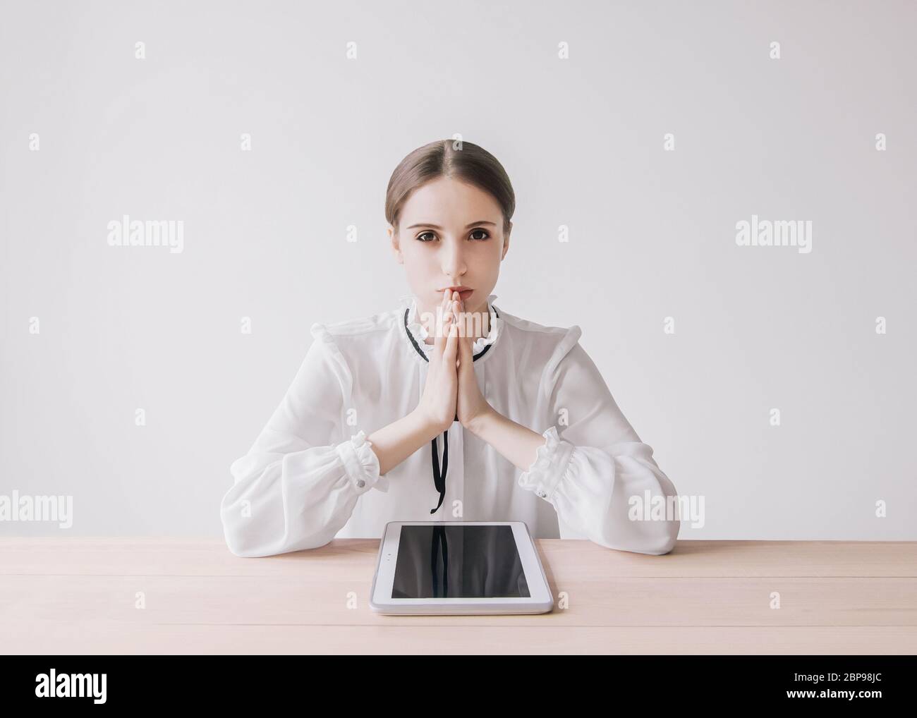 Pondering girl Photo with copy space Girl is sitting at a wooden table ...