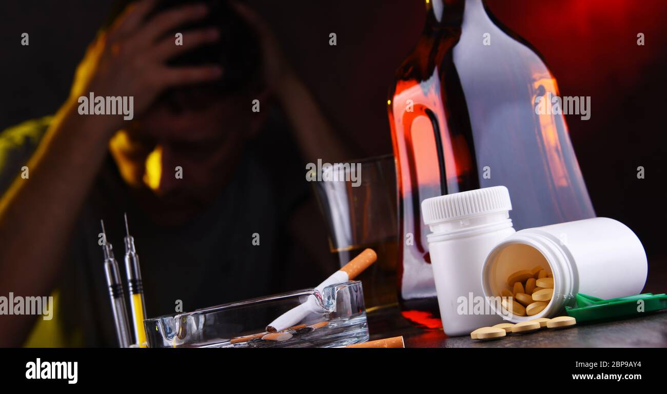 Addictive substances and the figure of a addicted man Stock Photo - Alamy