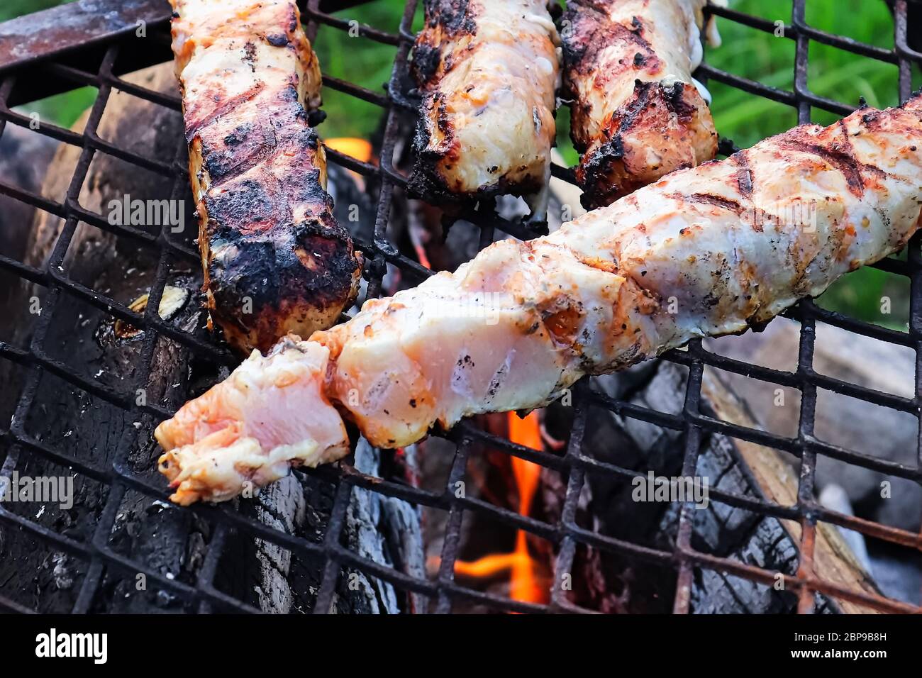 Closeup view of raw chicken meat on a BBQ Stock Photo - Alamy