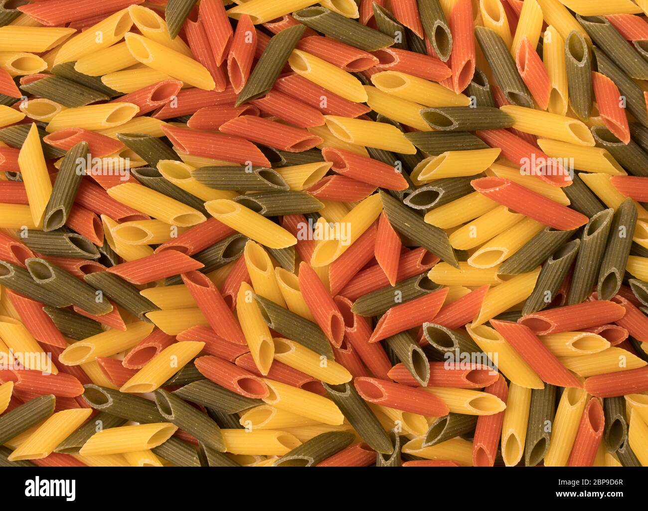 Tri-color penne pasta. Tomato, spinach and wheat pastas. Top view Stock ...
