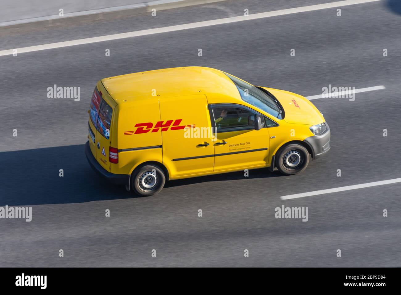 DHL world wide courier company delivery small cargo car on the highway ...