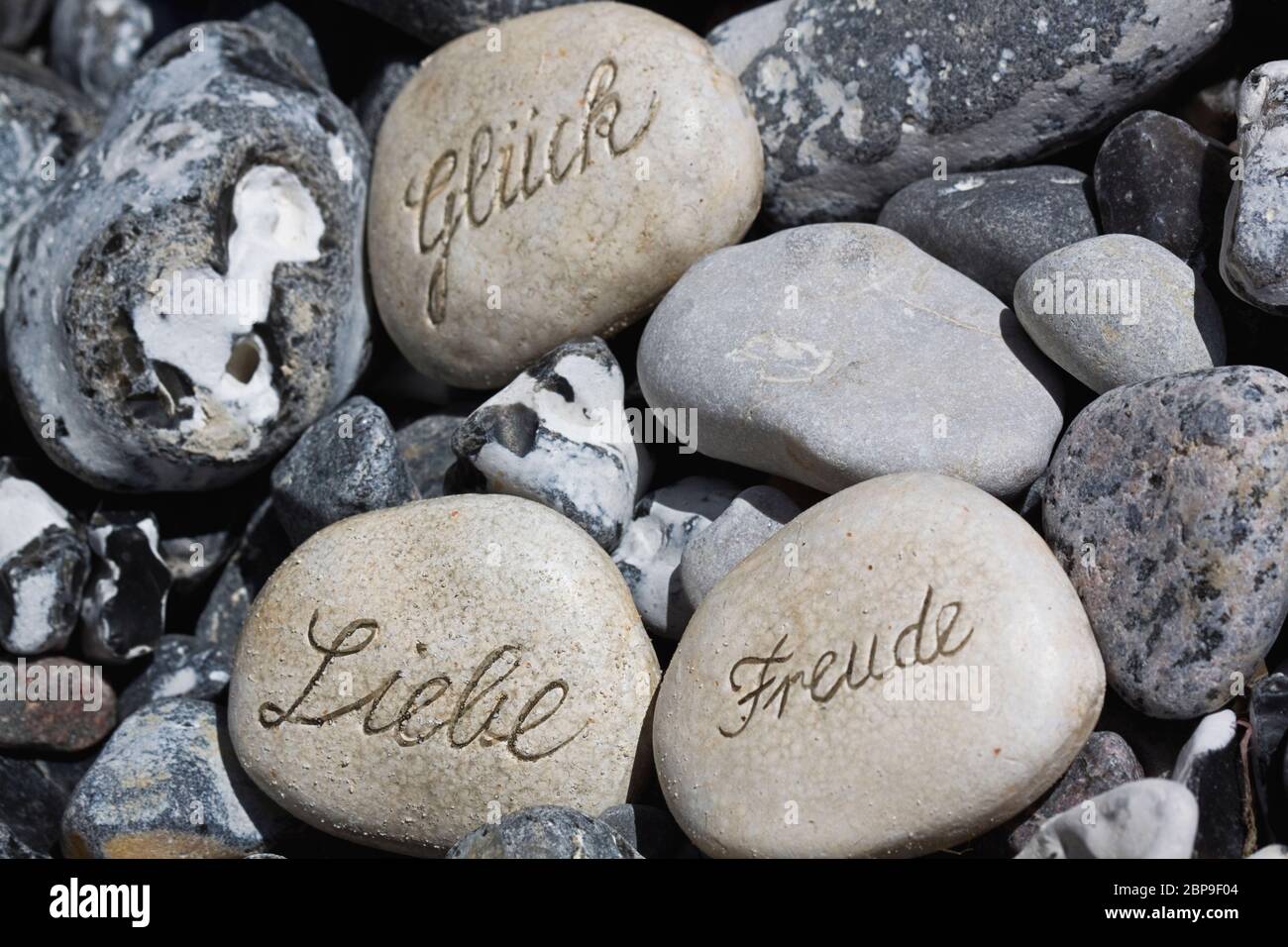 engraved stones with german words for joy, luck and love Stock Photo ...