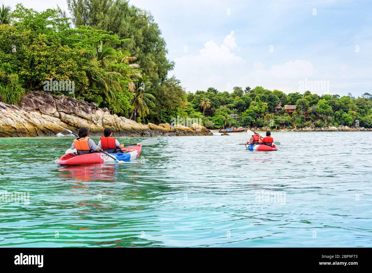 Tourist group are kayaking on the sea, travel by boat to see the ...