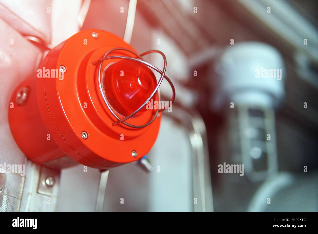 Red warning light of an emergency beacon at an industrial facility. A ...