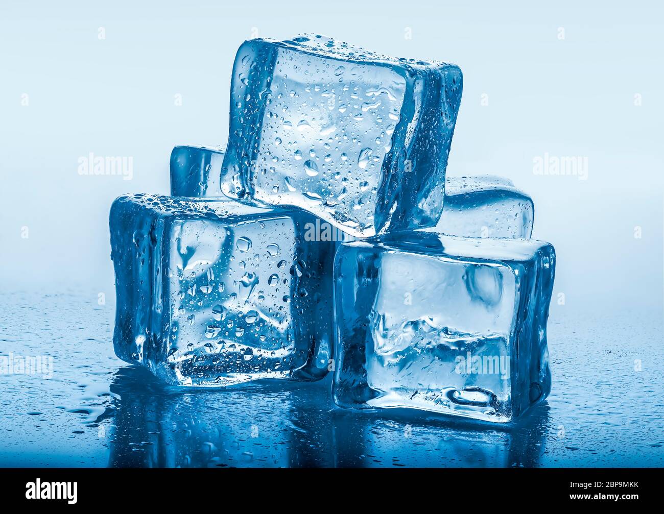 Pyramid of ice cubes on a blue background Stock Photo - Alamy