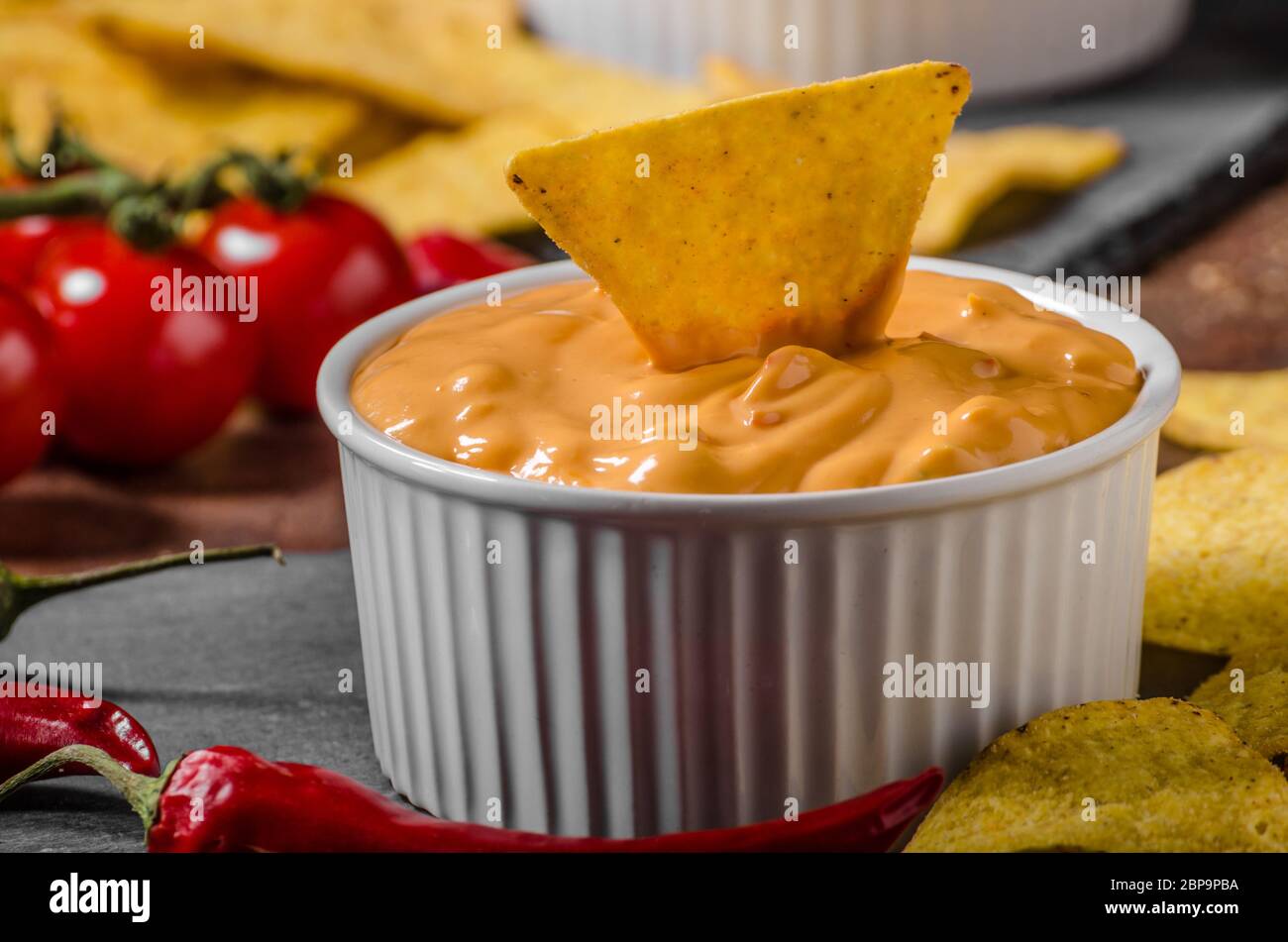 Tortilla chips with two dips, chilli hot and cheese dip Stock Photo - Alamy
