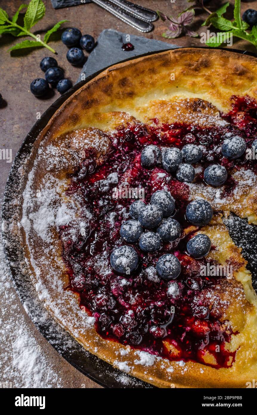 Dutch style pancake named dutch baby, baked in oven on iron skillet ...