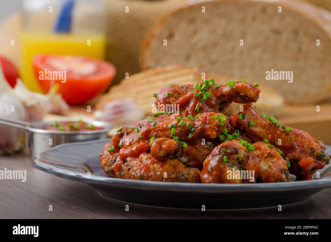 Spicy chicken wings, beer bread panini toast with garlic Stock Photo ...