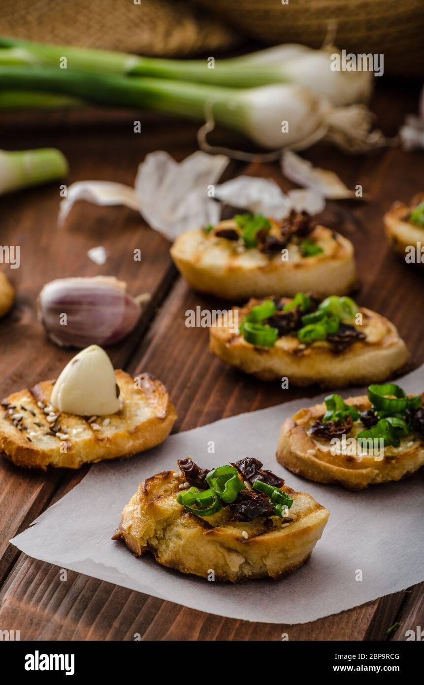 Mini toasts with garlic and dried tomato, sprinkled with herbs Stock ...