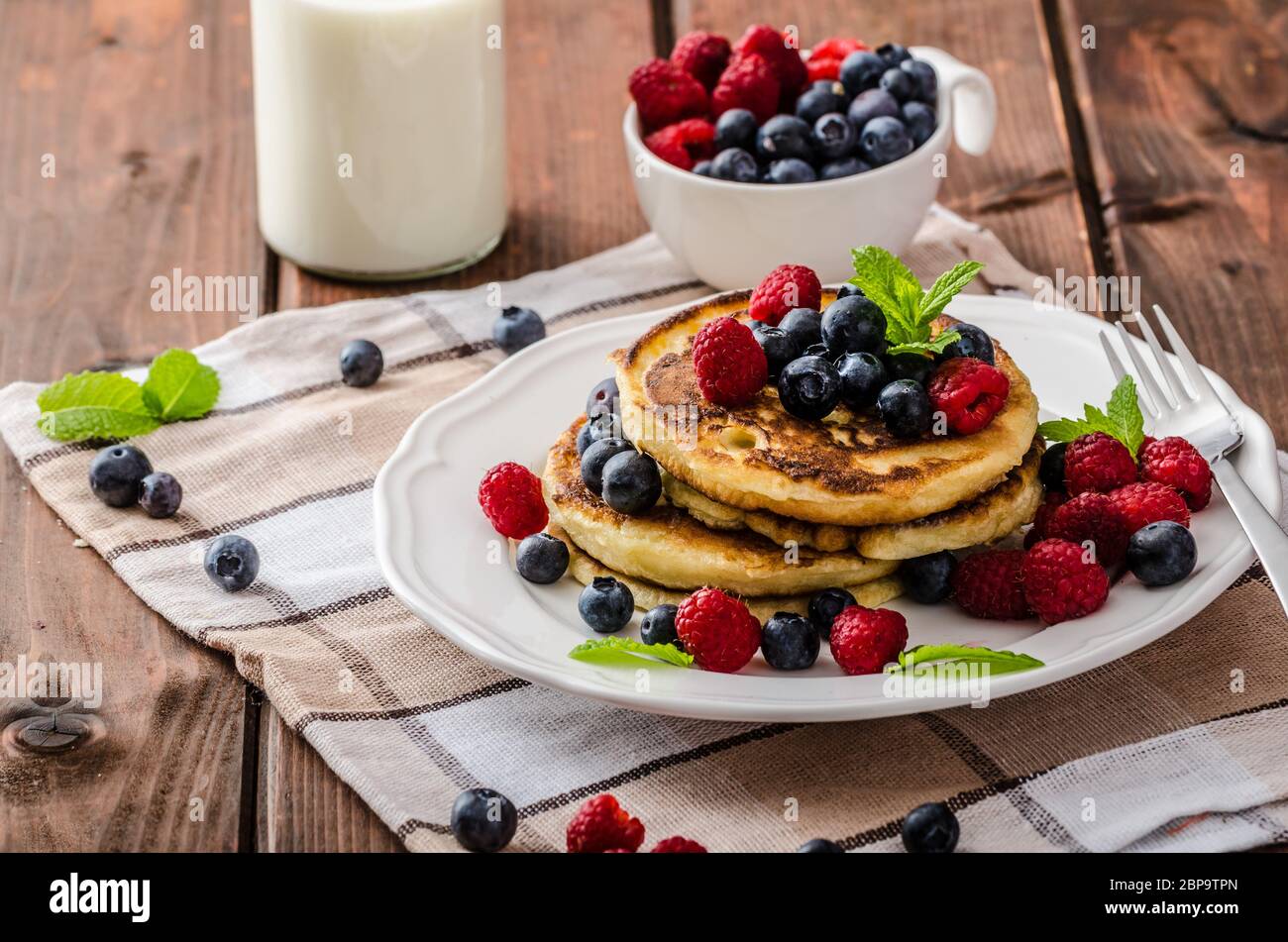 Pancakes with forest fruit and mint, fresh fruits and milk Stock Photo ...