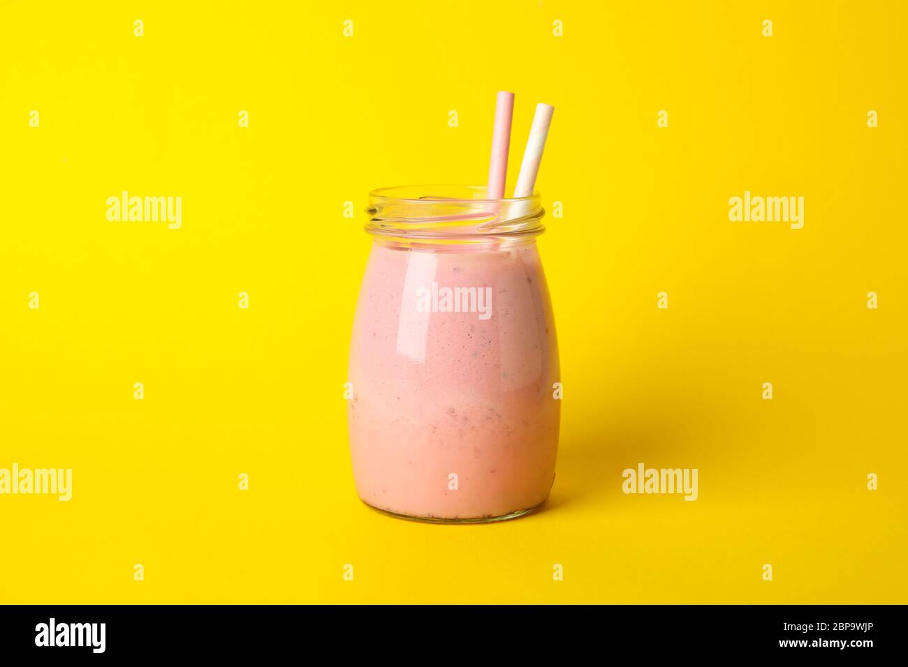 Delicious strawberry milkshake on yellow background. Summer drink Stock ...