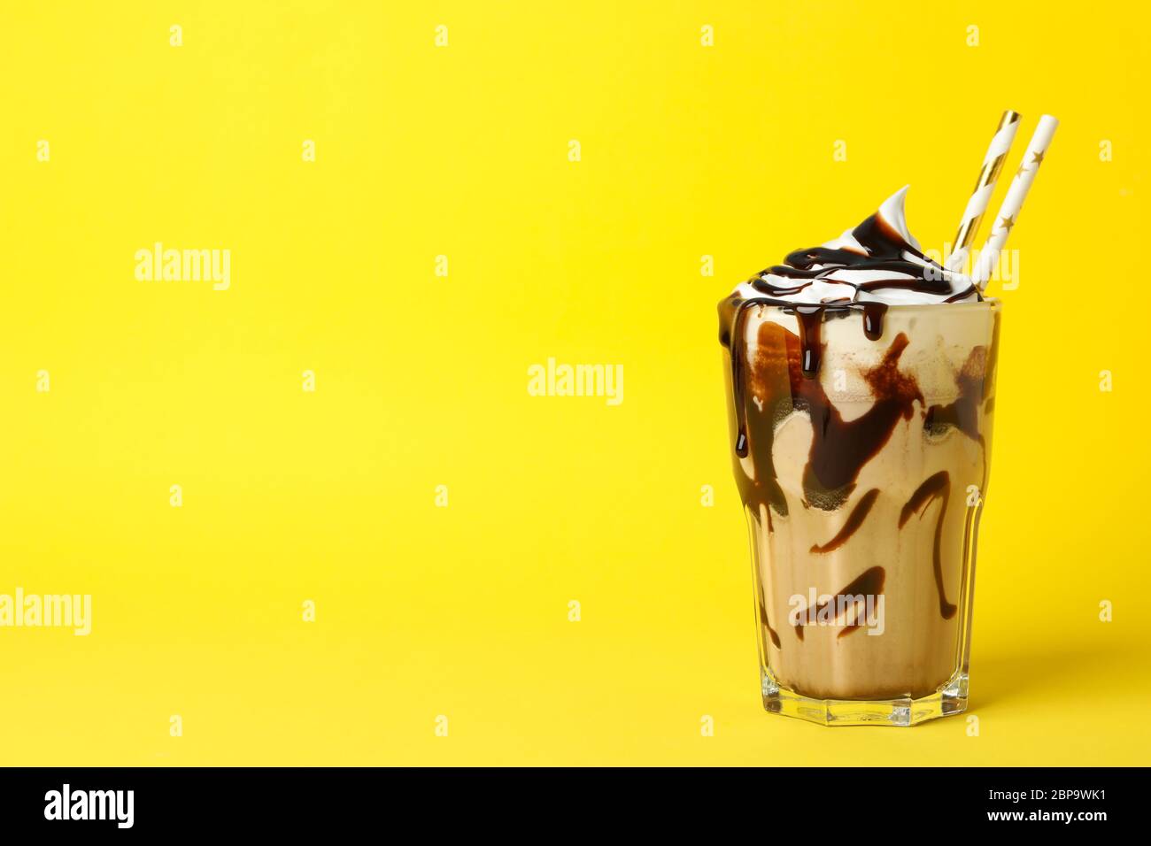 Glass of chocolate milkshake on yellow background. Summer drink Stock ...