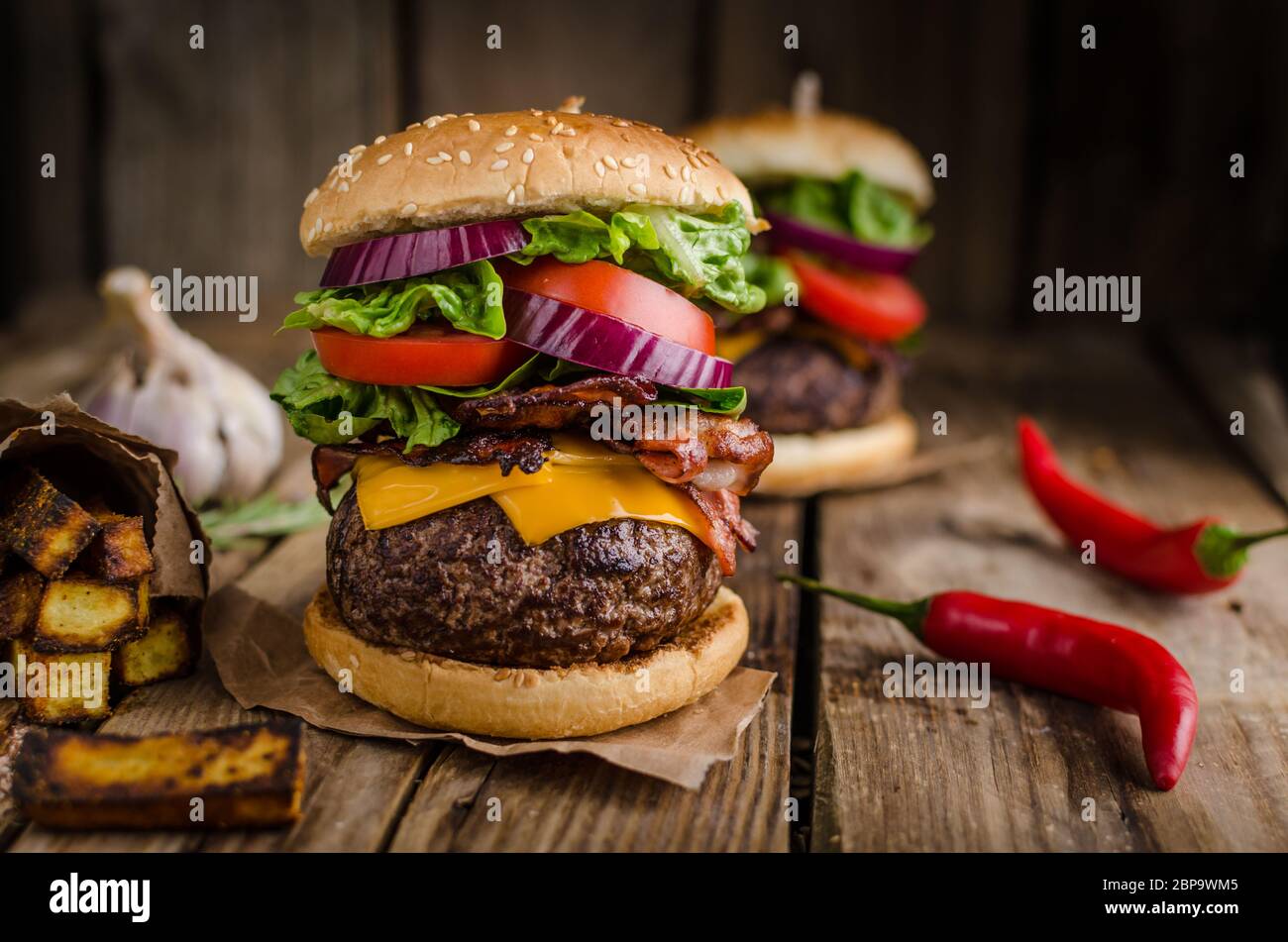 Beef burger rustic style, with chilli peppers and homemade french fries ...