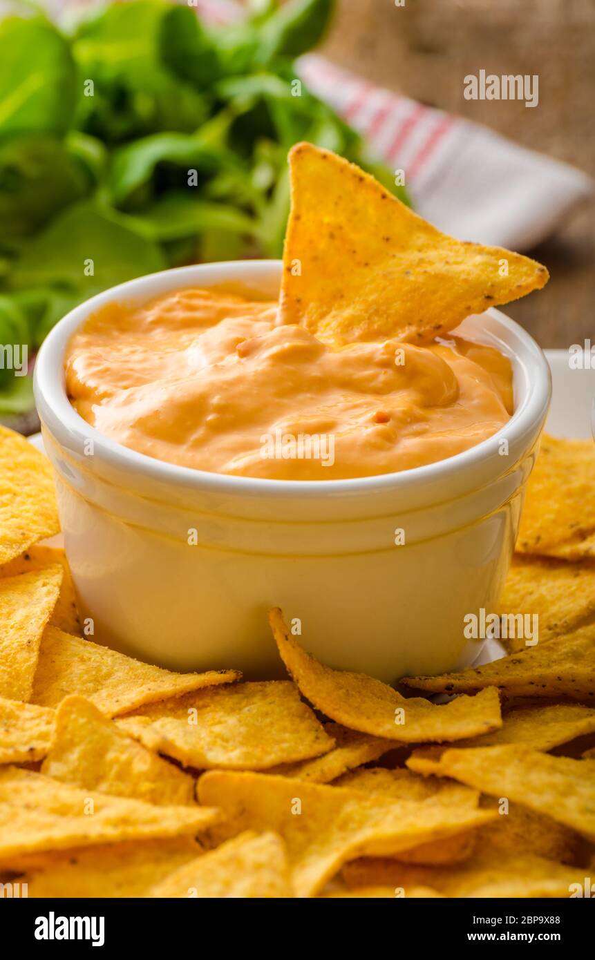 Tortilla chips with cheese dip and barbecue, czech beer Stock Photo - Alamy