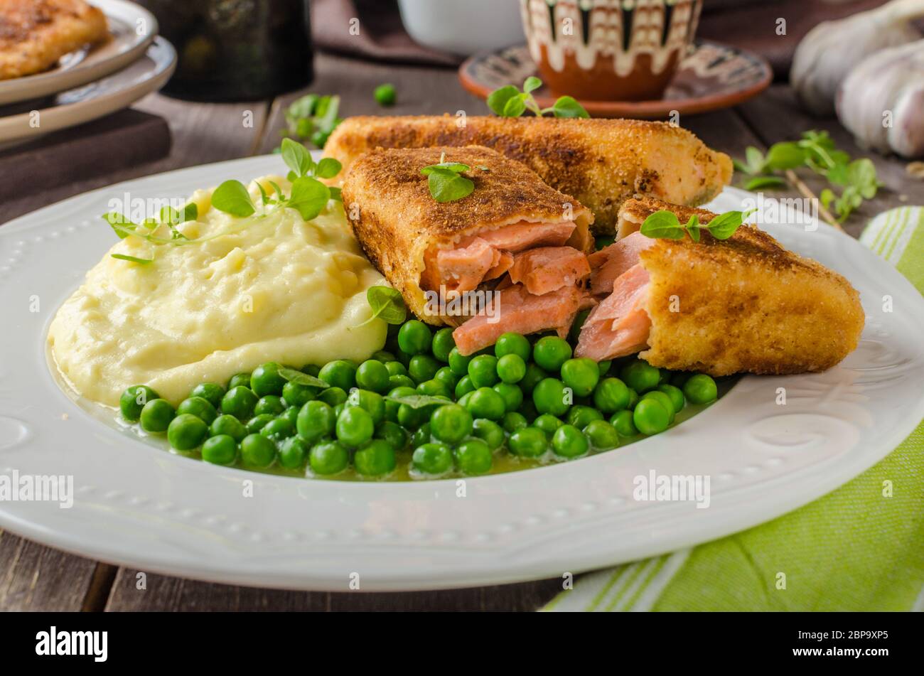 Fried salmon in herb crust with peas and mashed Stock Photo - Alamy