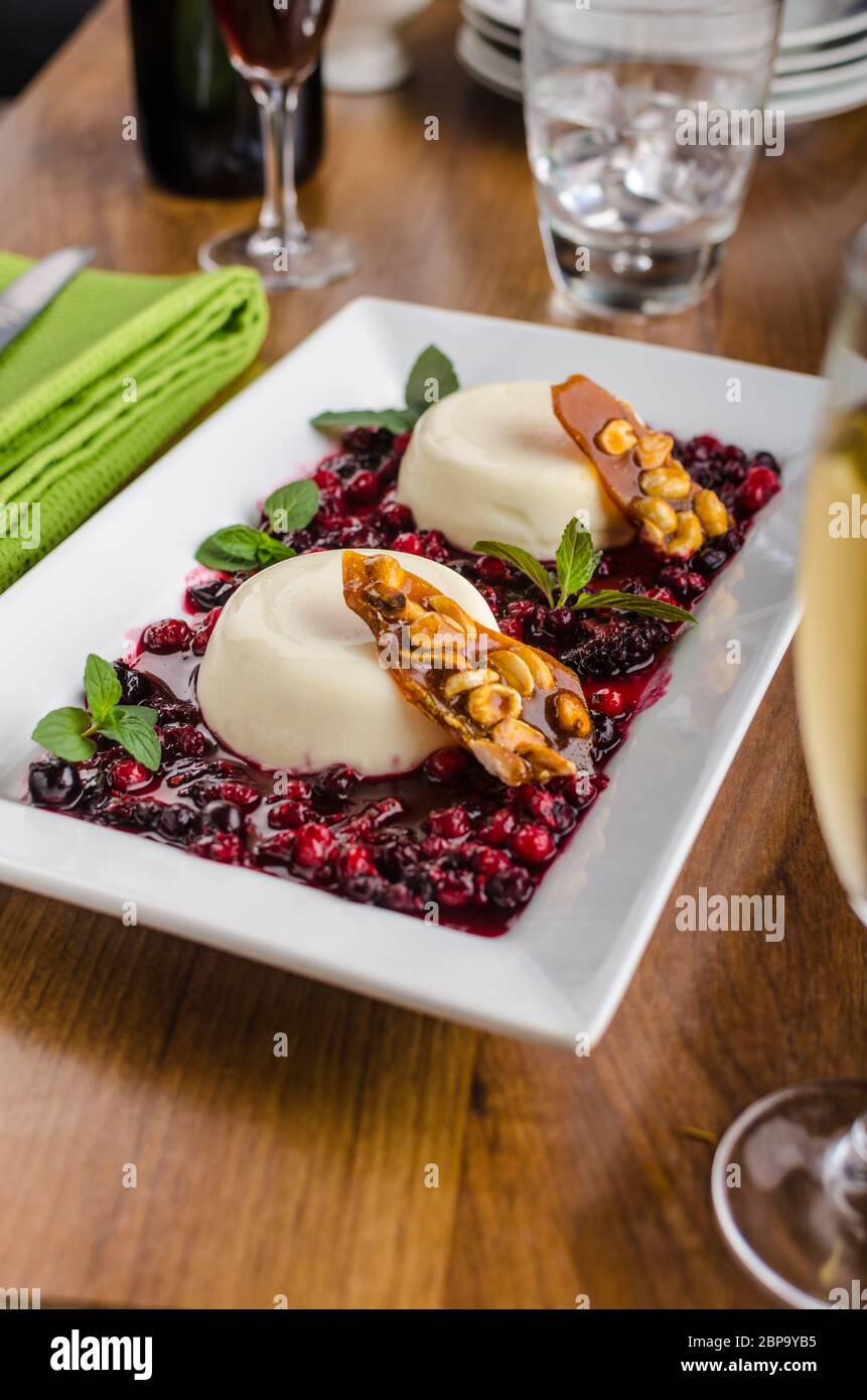 Vanilla panna cotta with forest fruit and caramel chips, restaurant ...