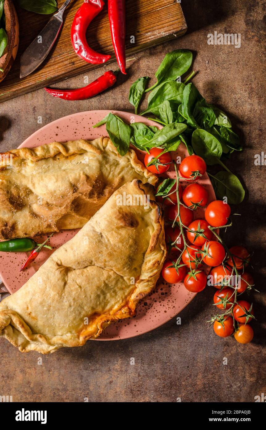 Calzone pizza, stuffed with tomato and herbs sauce, baked to crispy Stock Photo - Alamy
