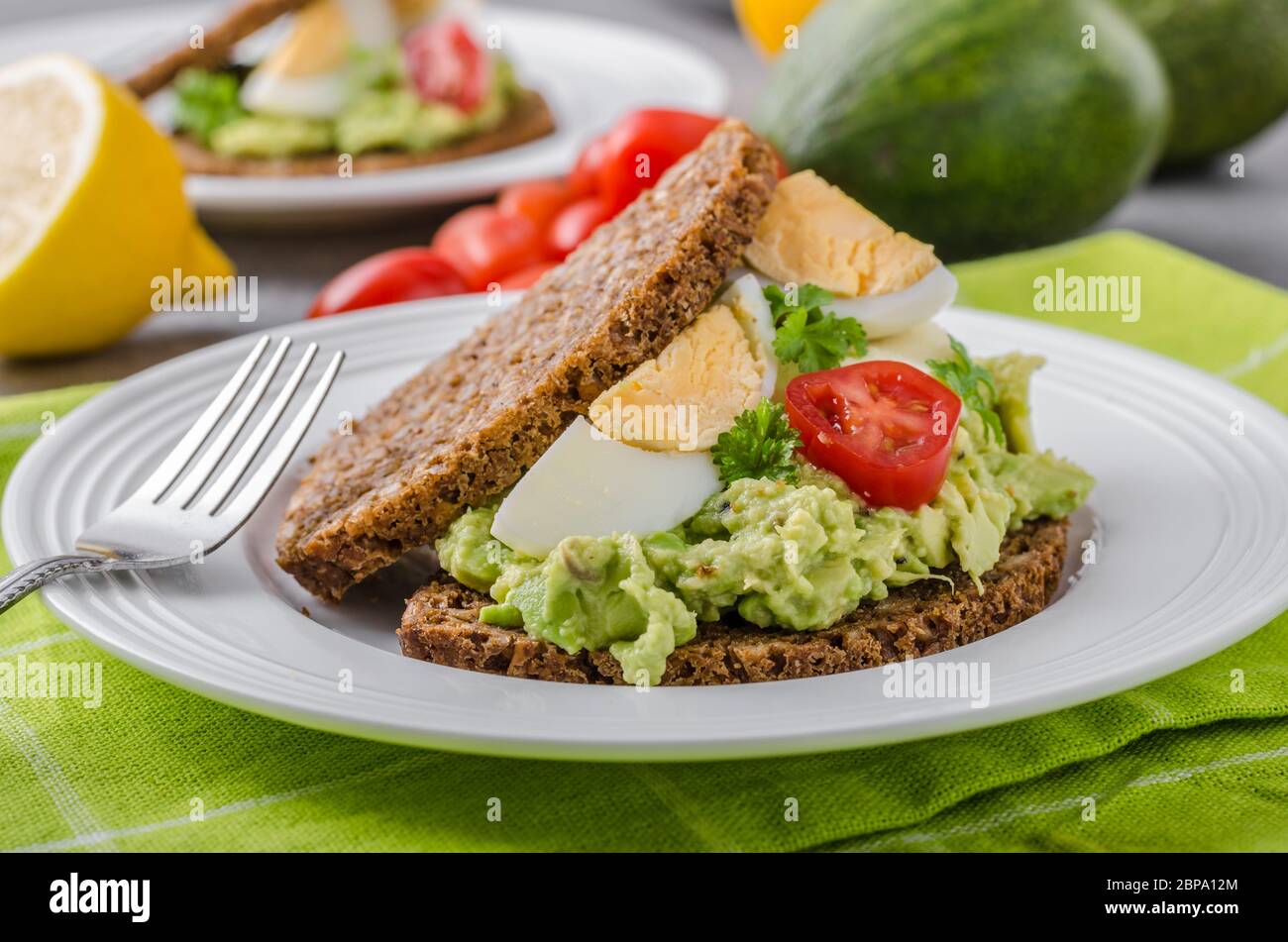 Healthy bread with avocado spread, lemon, vegetable and eggs Stock ...