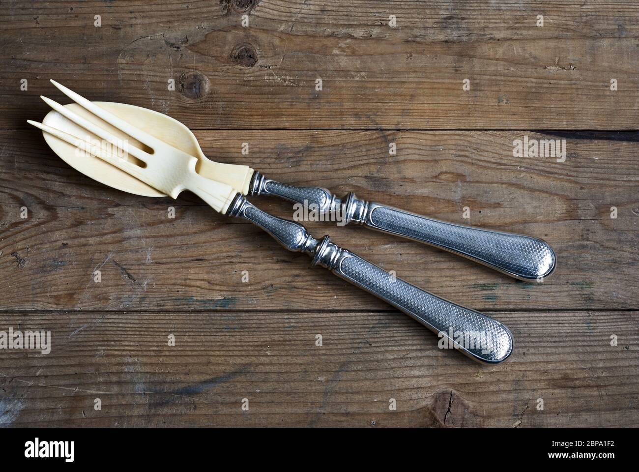 Antique dining silverware with ivory handle, set on old rustic wood ...