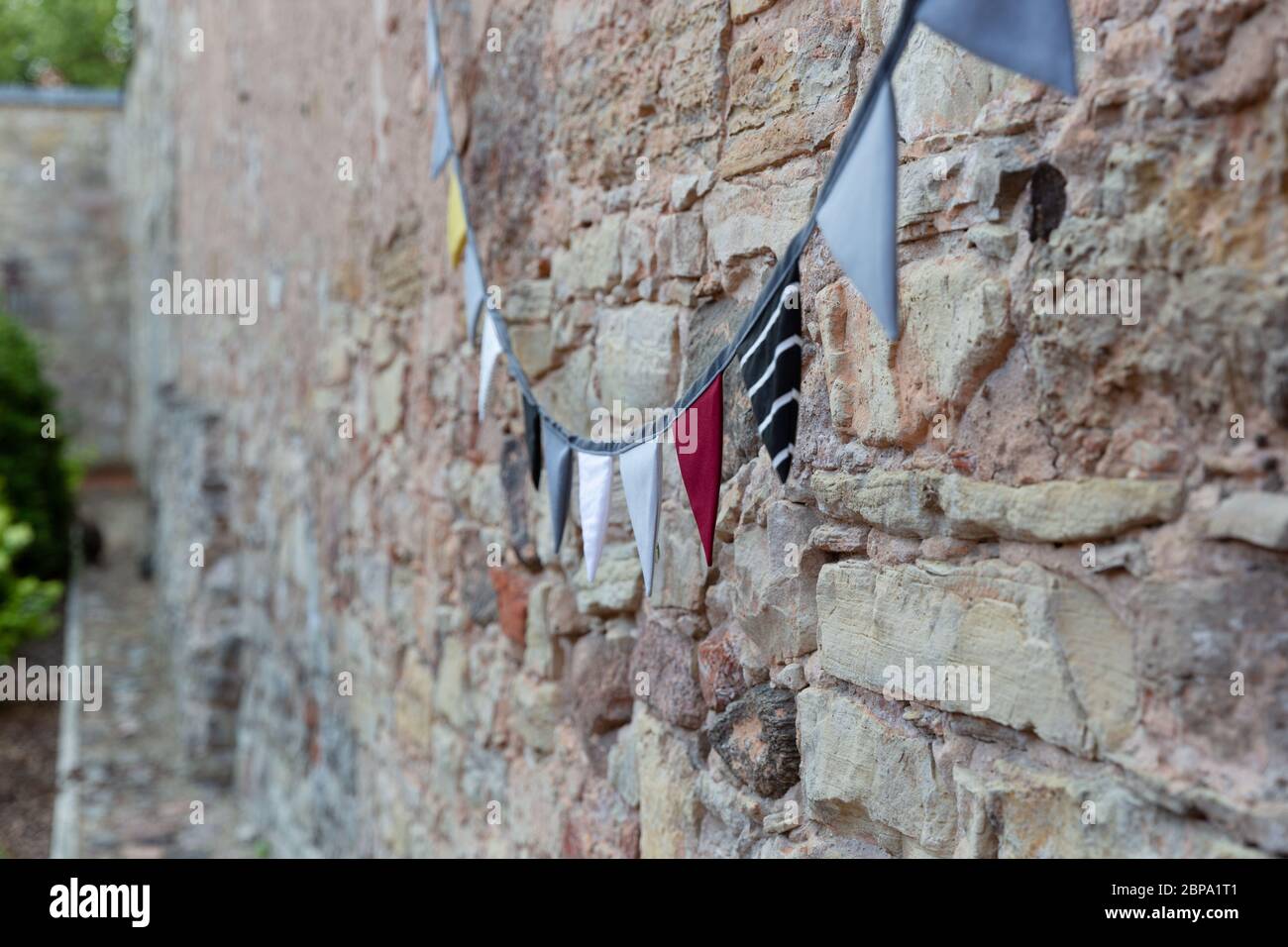 Outdoor building brick wall decorated with vintage fabric par flags ...