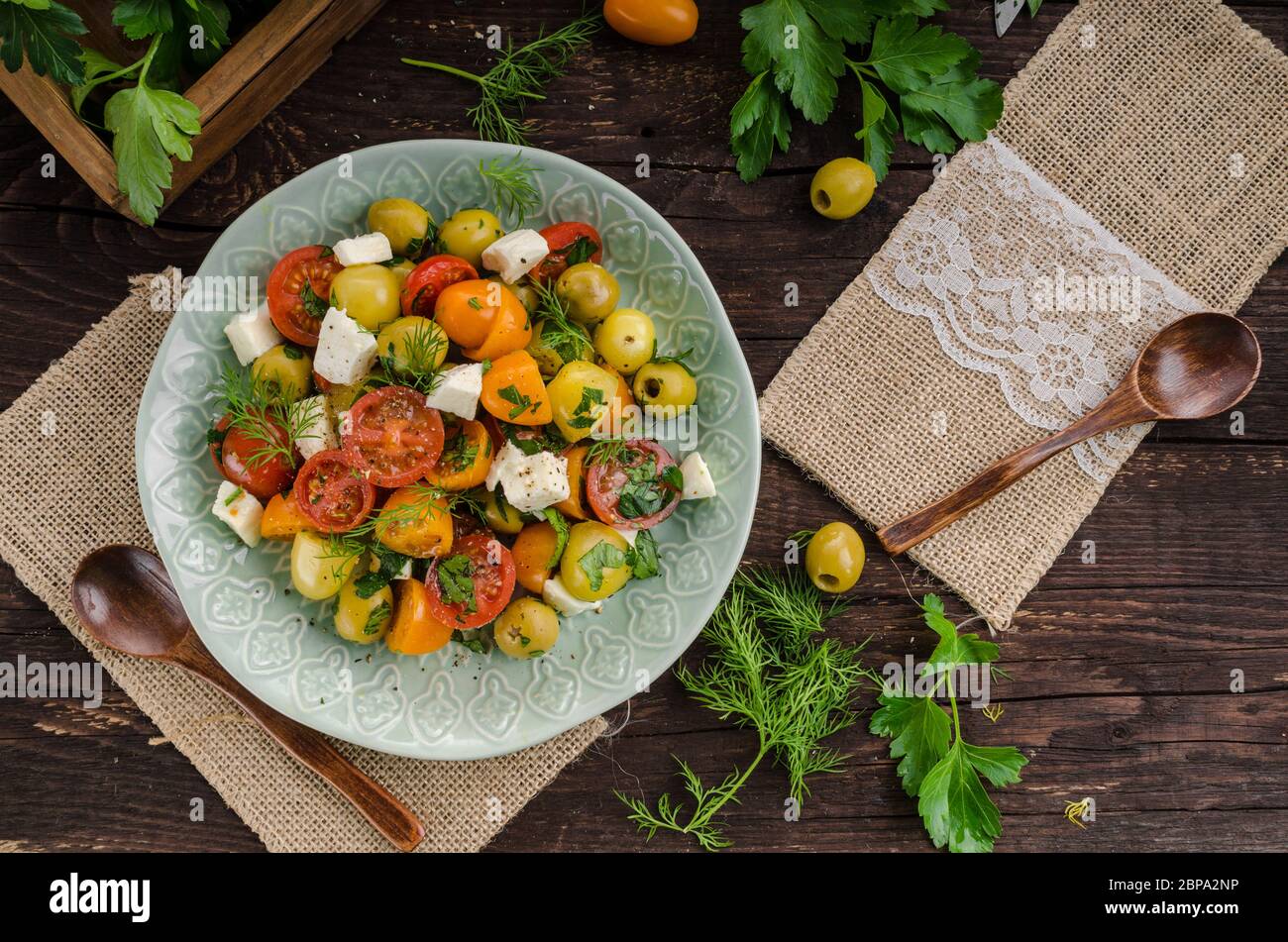Fresh tomato olives salad, herbs and feta cheese inside Stock Photo - Alamy
