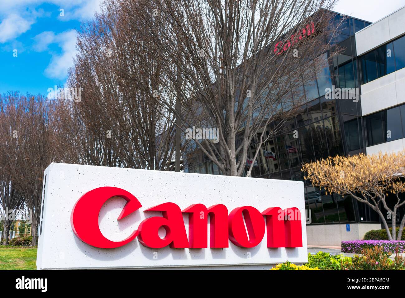 Canon logo on sign post at headquarters of Canon Solutions America in ...