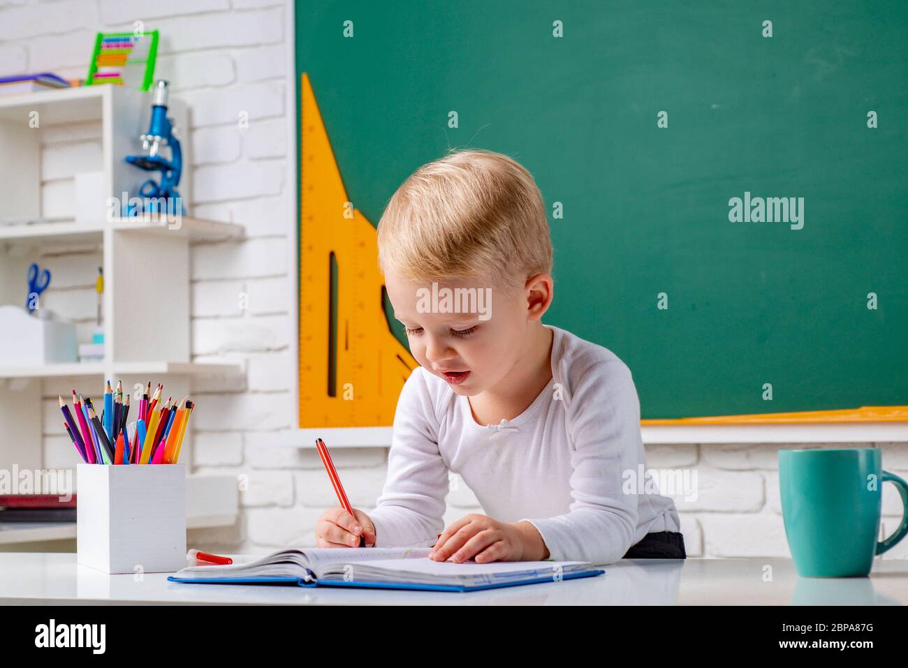 Kid gets ready for school. Cute little preschool kid boy with teacher ...