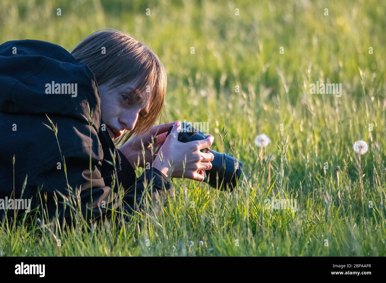 Boy using camera to take pictures Stock Photo - Alamy