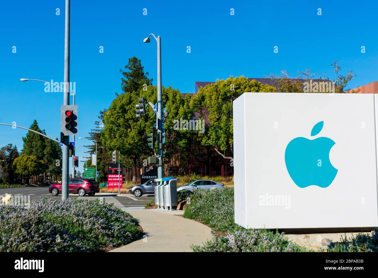 Apple logo on the sign advertising the street entrance to the campus of ...