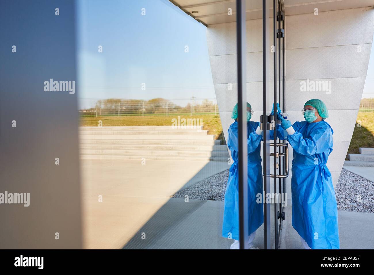 Cleaning staff disinfecting the entrance area of ??a clinic due to ...