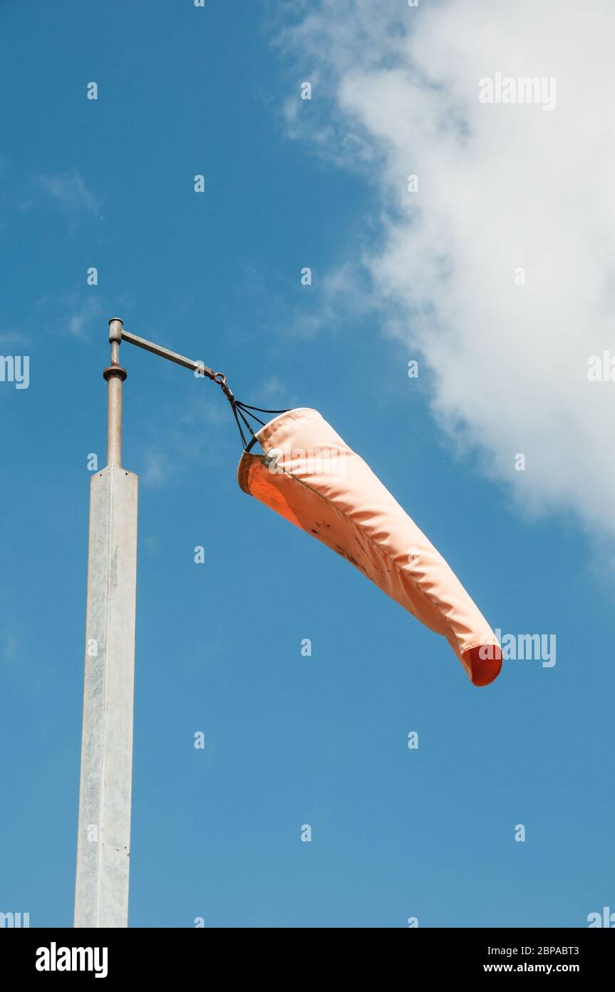 Around the UK - Wind Sock against a blue sky with white fluffy clouds ...