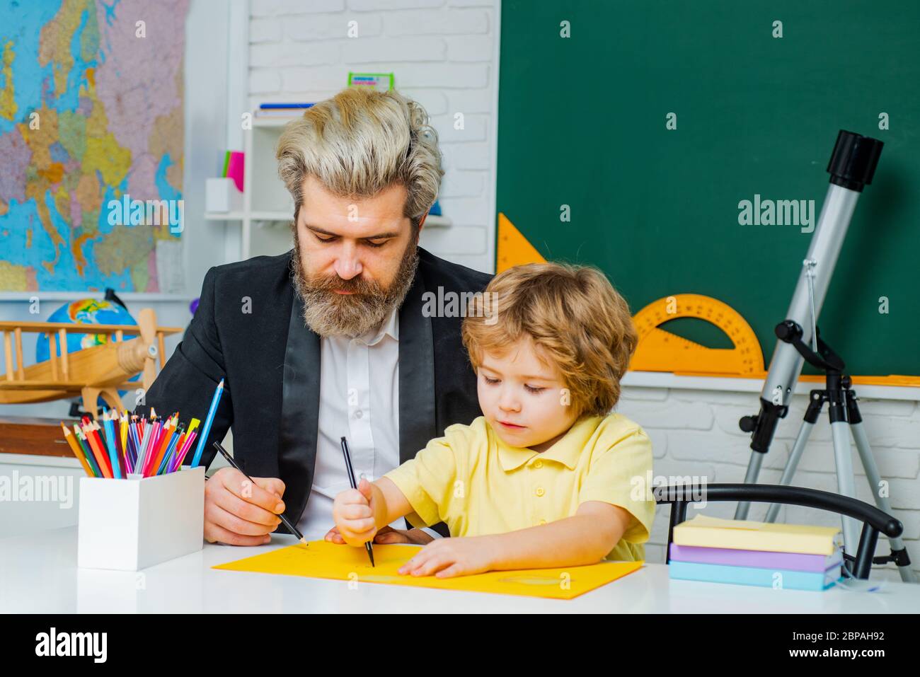 Father teaching son. Father and son together schooling. Kid and teacher ...