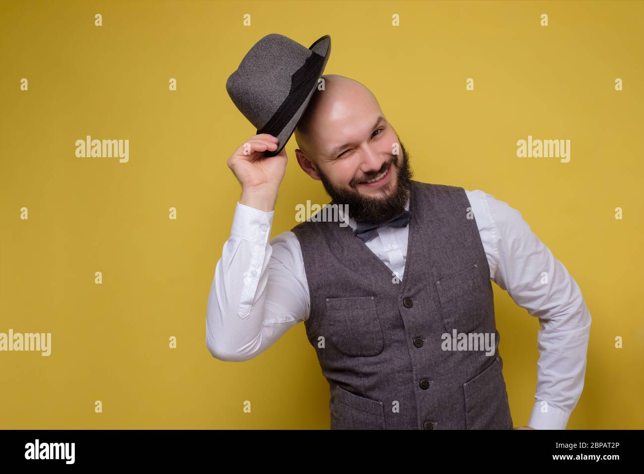 Handsome man with hat is smiling and saluting. Hello my friends concept ...