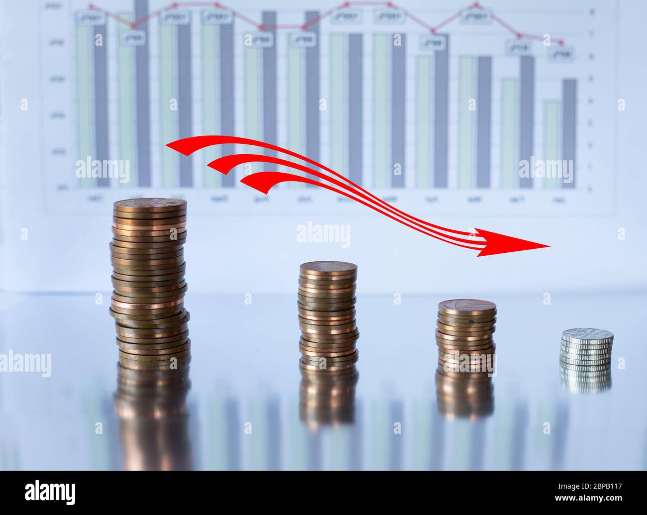Downward red arrow icon on background of coins money and graphs ...
