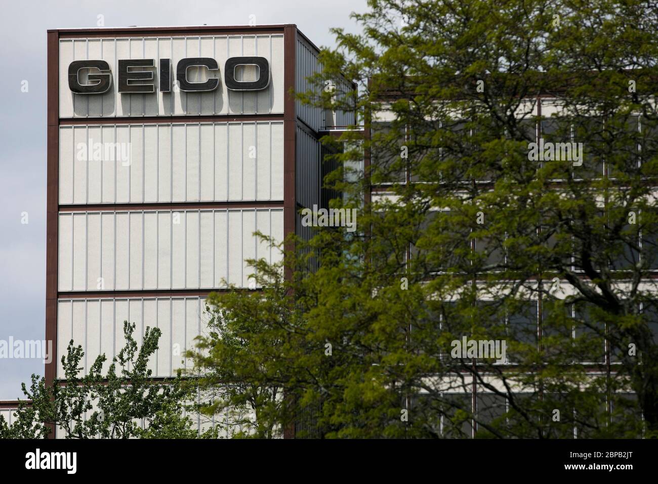 A logo sign outside of the headquarters of The Government Employees Insurance Company (GEICO) in ...