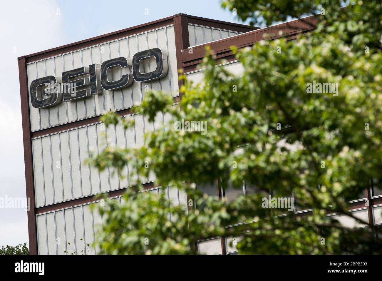 A logo sign outside of the headquarters of The Government Employees Insurance Company (GEICO) in ...
