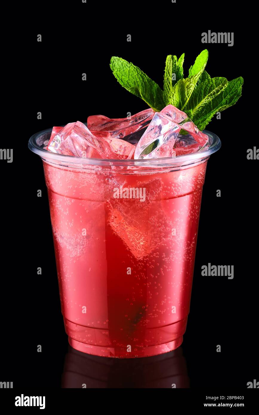 Cold fizz cocktail with strawberry in take away cup isolated on black ...