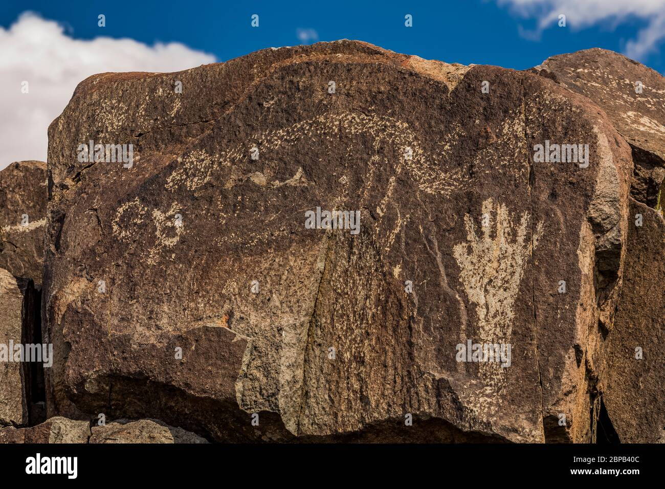 Rock art with human hand and rattlesnake motifs created long ago by ...
