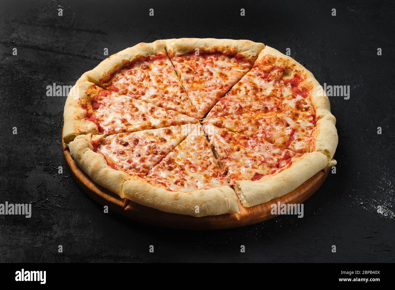 Cheese pizza cut in slices Stock Photo - Alamy
