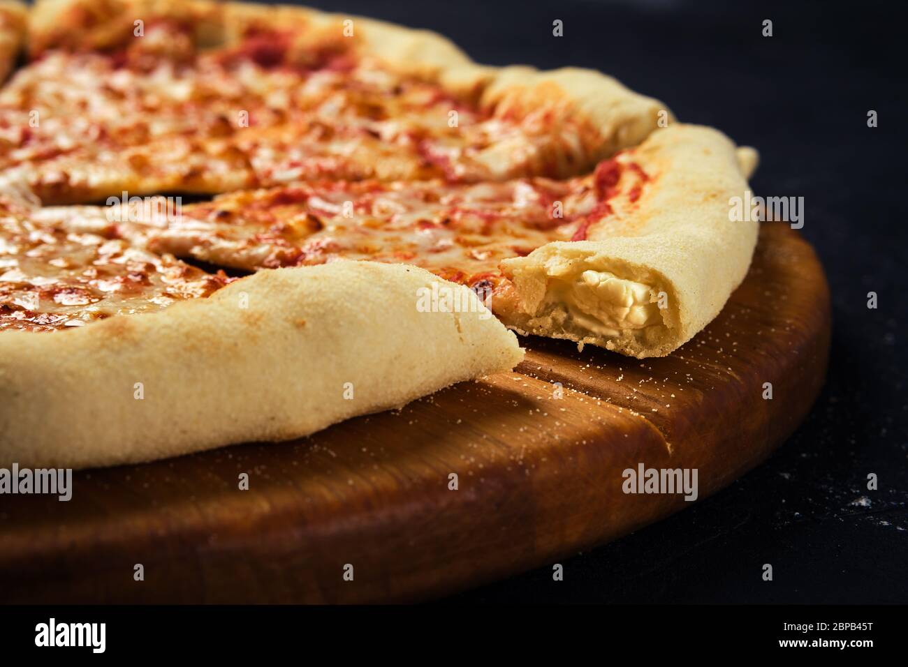 Cheese pizza cut in slices Stock Photo - Alamy