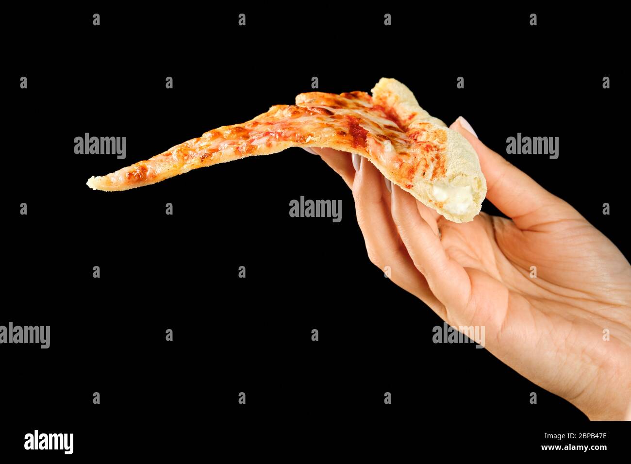 Hand holding slice of cheese pizza cut in slices Stock Photo - Alamy