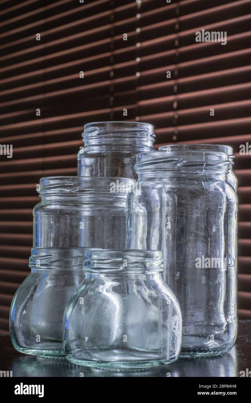 Six empty, used and slightly dirty glass jars Stock Photo - Alamy