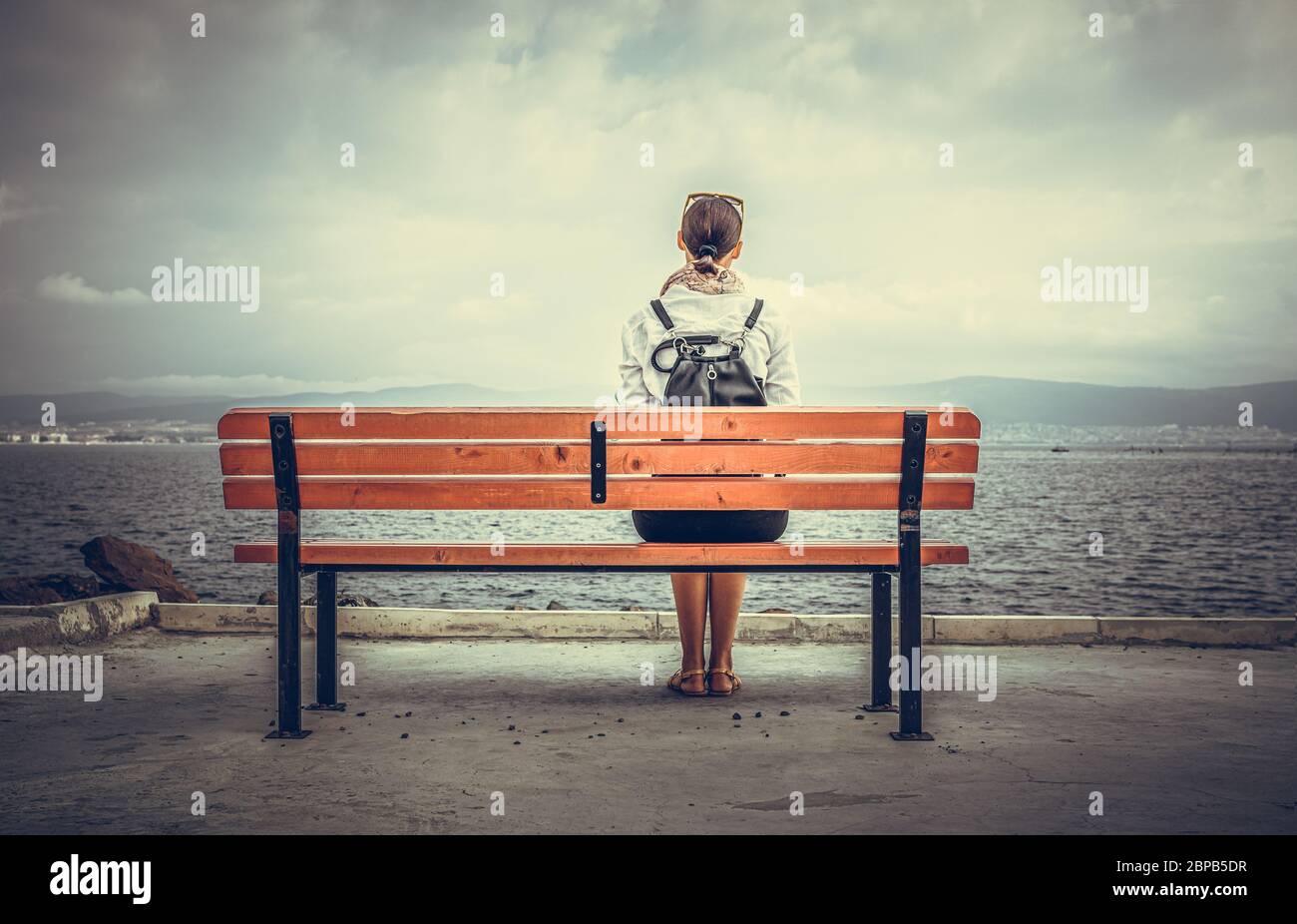 Image sad person sitting alone hi-res stock photography and images - Alamy