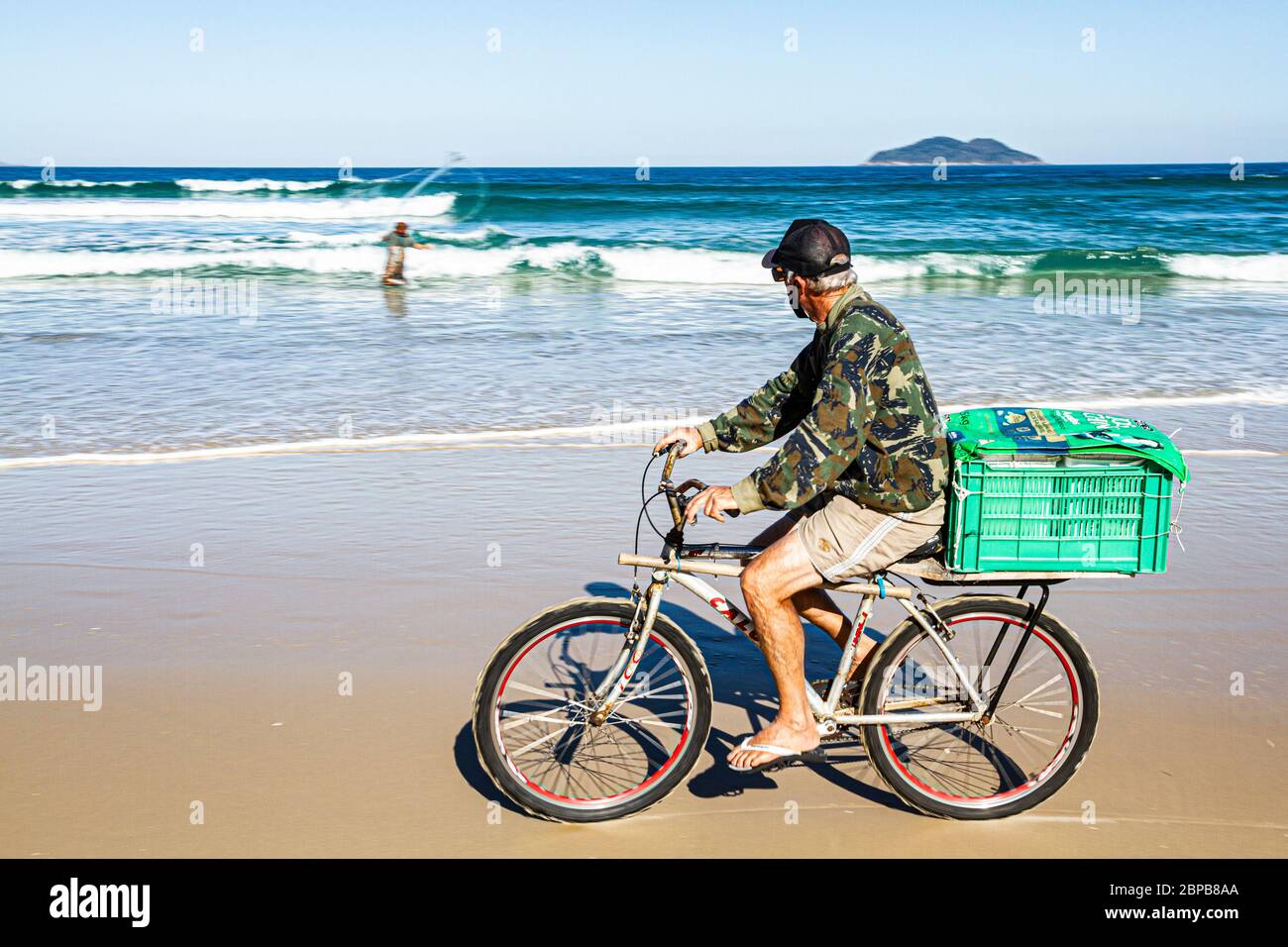 Man riding a bicycle at Acores Beach. Florianopolis, Santa Catarina ...