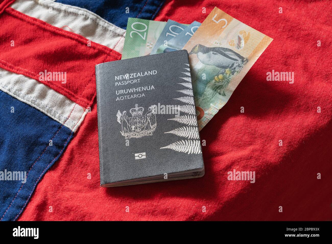 New Zealand passport on flag of country with currency Stock Photo - Alamy