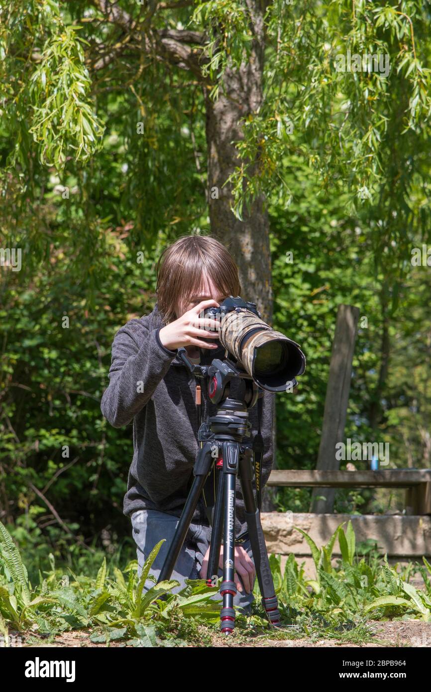 Boy taking picture with long lens Stock Photo - Alamy