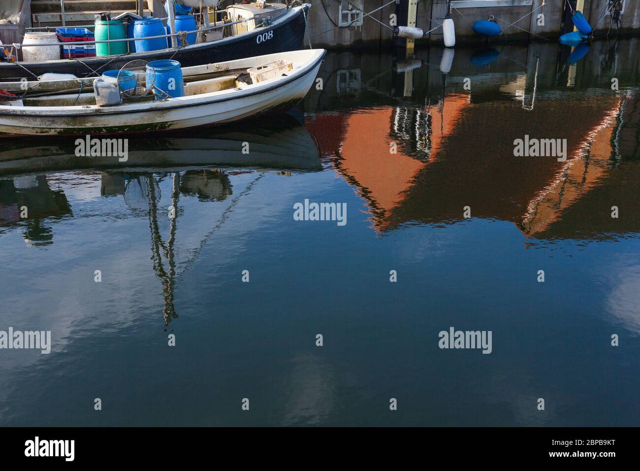 Small fishing ships are loaded with material on the quay fishing ...