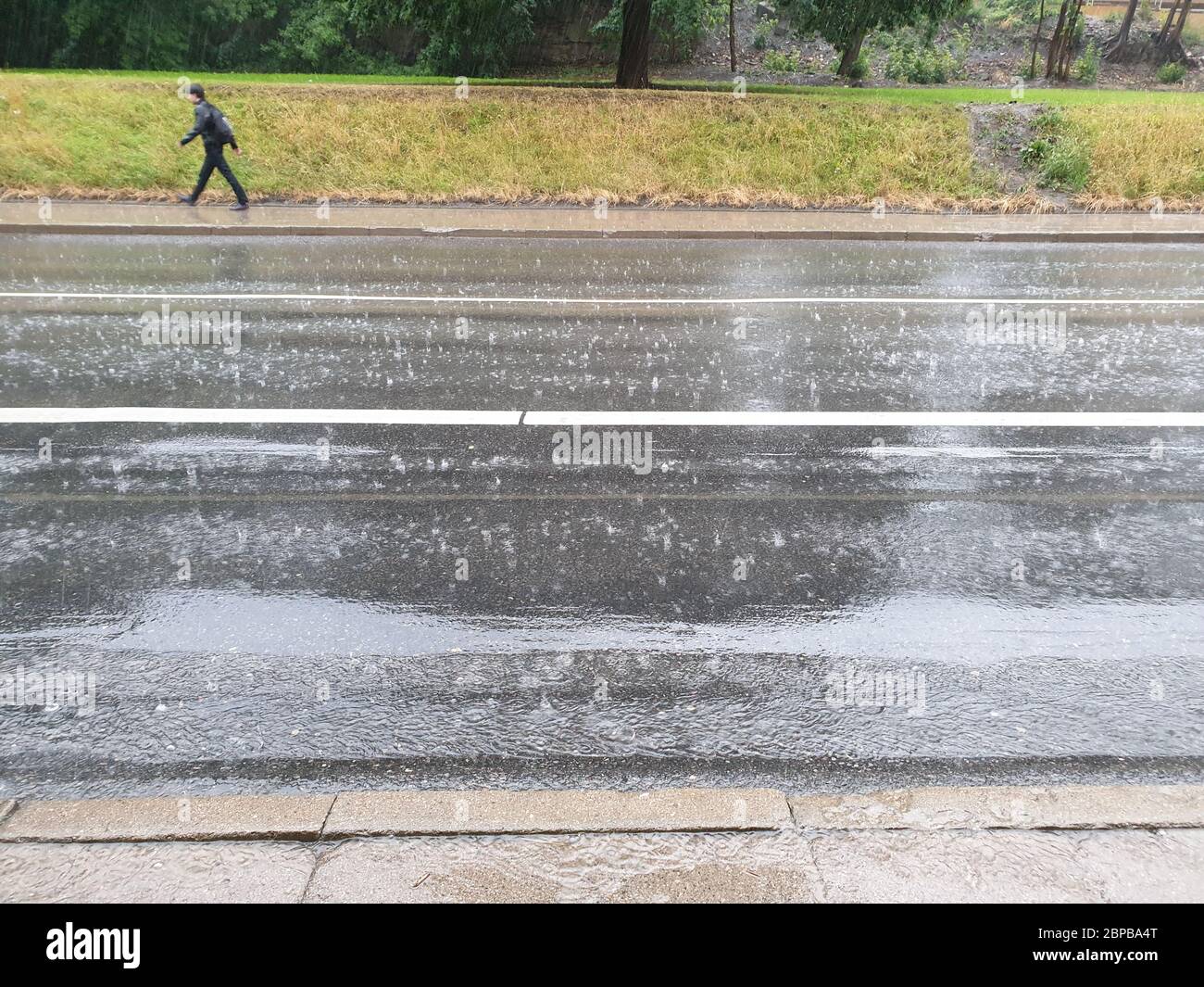 Heavy rain in the city. Street full of water Stock Photo - Alamy